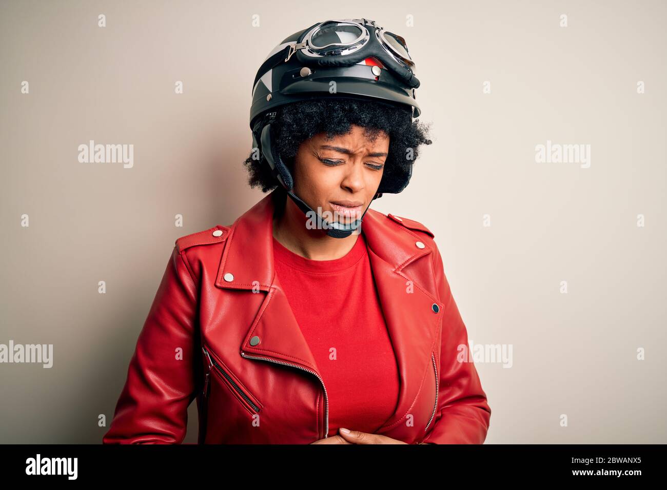 Young African American afro motorcyclist woman with curly hair wearing ...