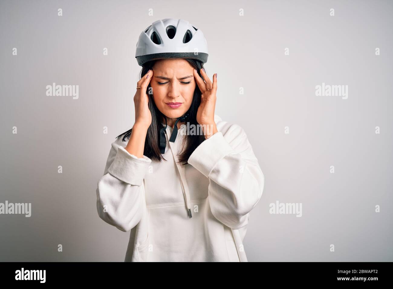 Young cyclist woman with blue eyes wearing bike helmet over isolated ...