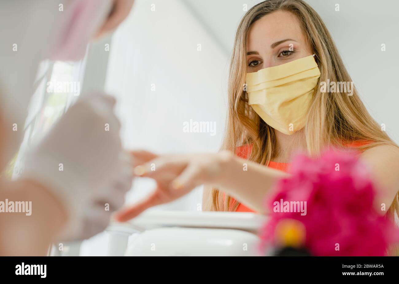 Woman with face mask during manicure in nail salon Stock Photo - Alamy
