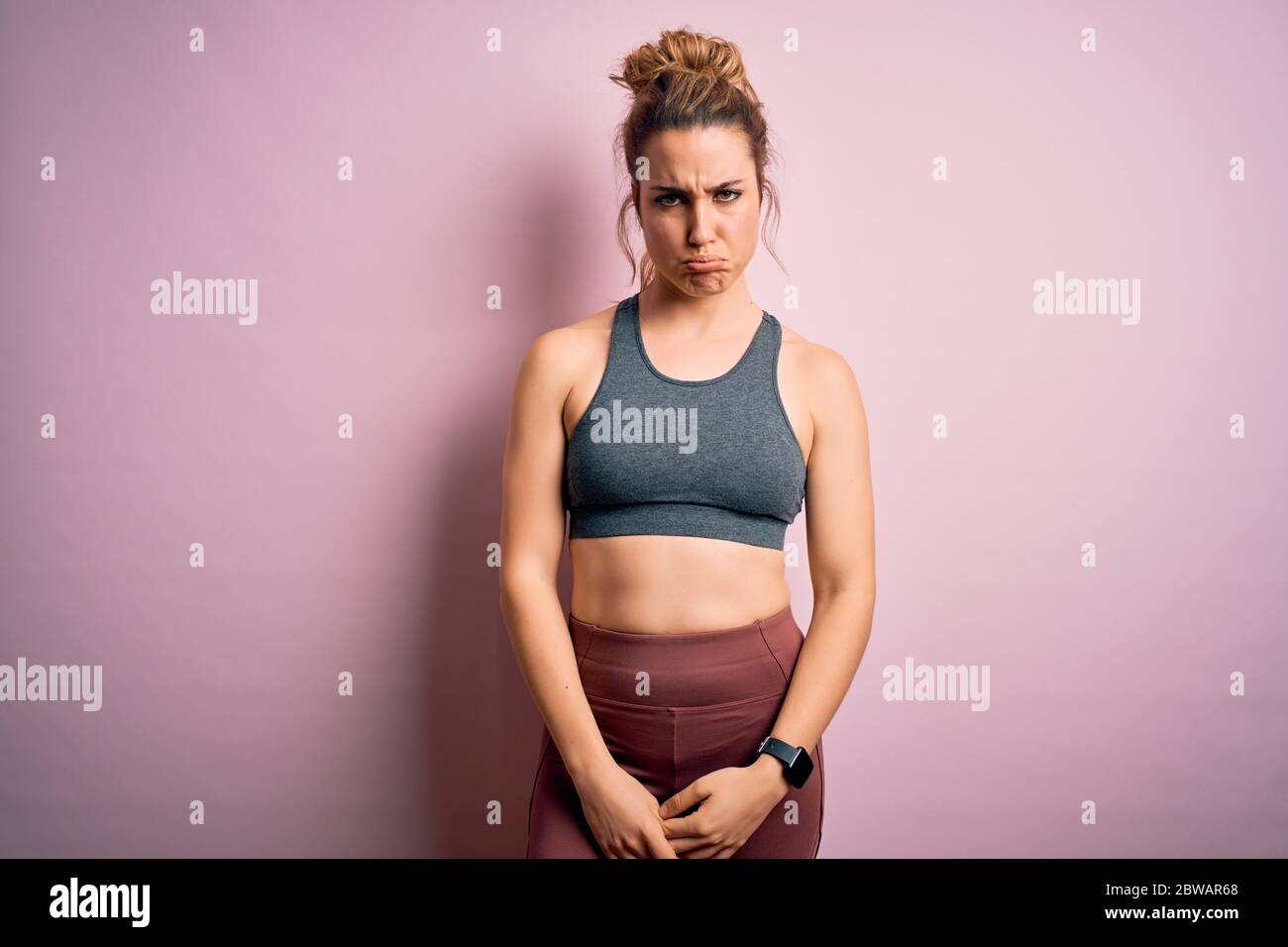 Young beautiful blonde sportswoman doing sport wearing sportswear over ...