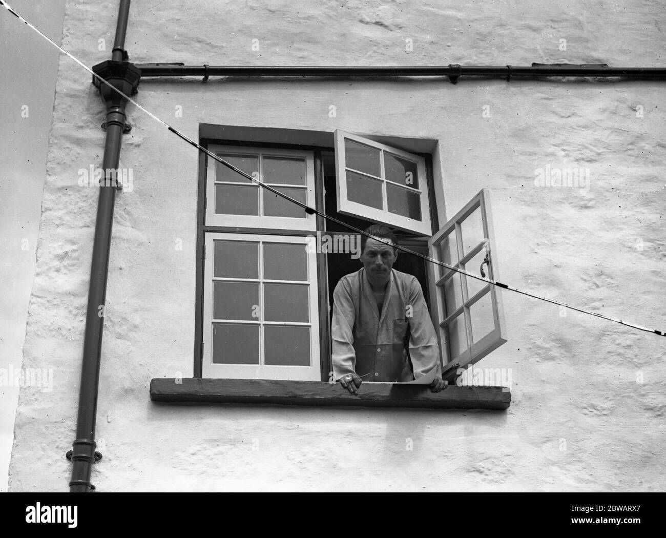 Mr Compton Mackenzie looking out of the window of his island home on ...