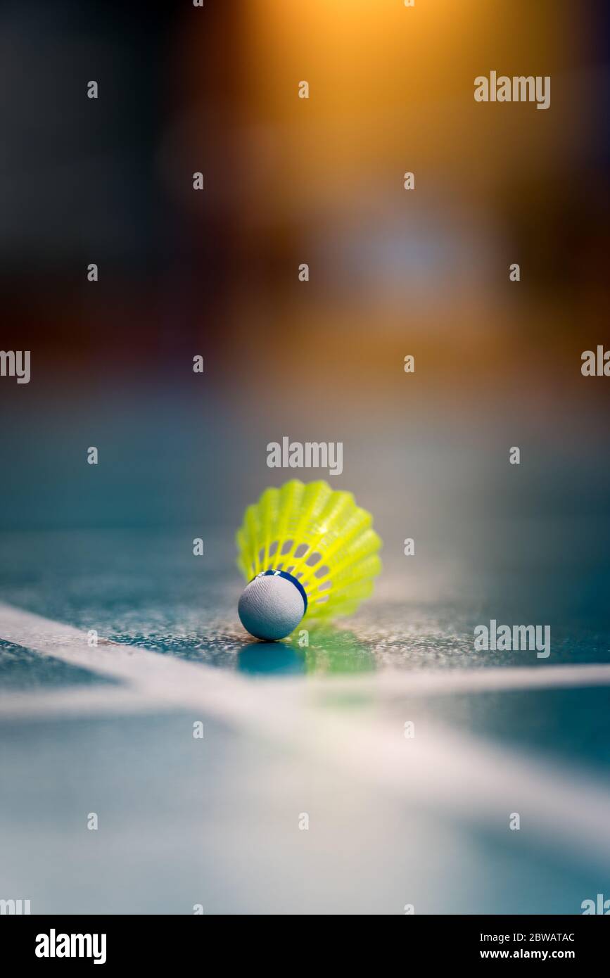 Badminton yellow shuttlecock on the green floor Stock Photo - Alamy