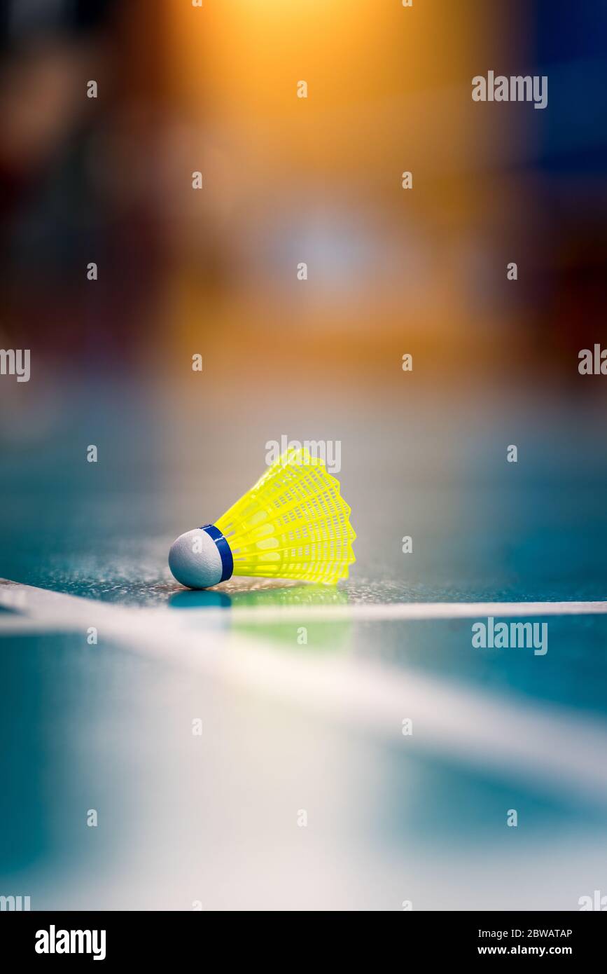 Badminton yellow shuttlecock on the green floor Stock Photo - Alamy
