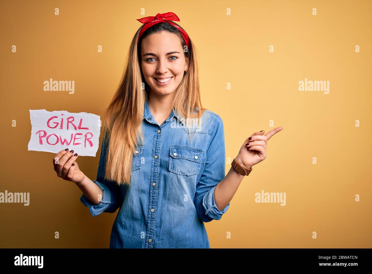 Blonde woman with blue eyes asking for girls rights holding banner with ...