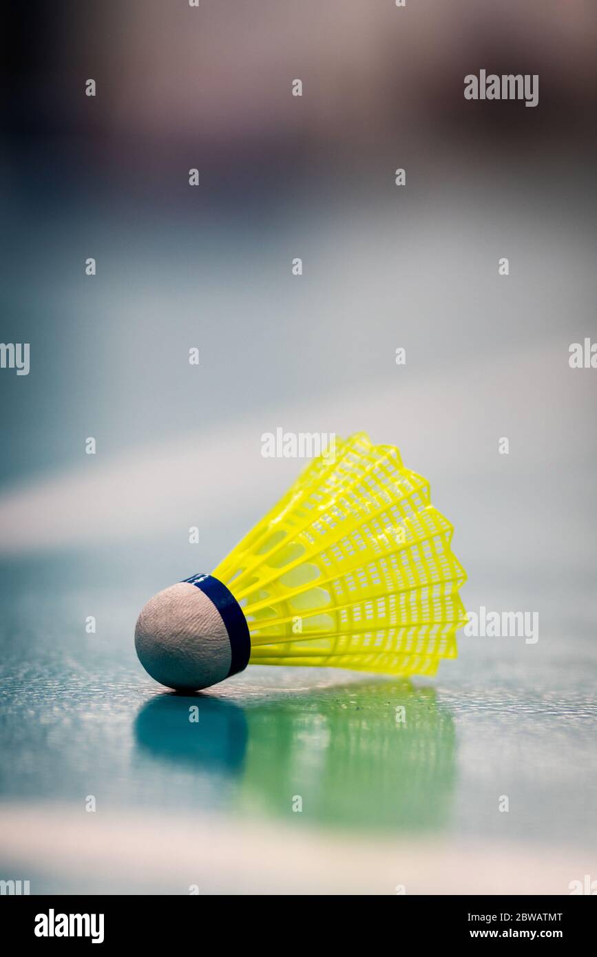 Badminton yellow shuttlecock on the green floor Stock Photo - Alamy