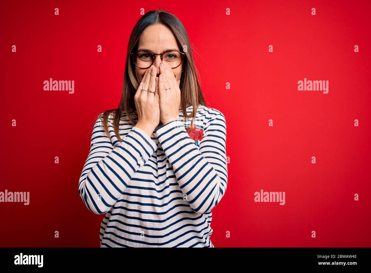 Young beautiful blonde woman with blue eyes wearing glasses standing ...