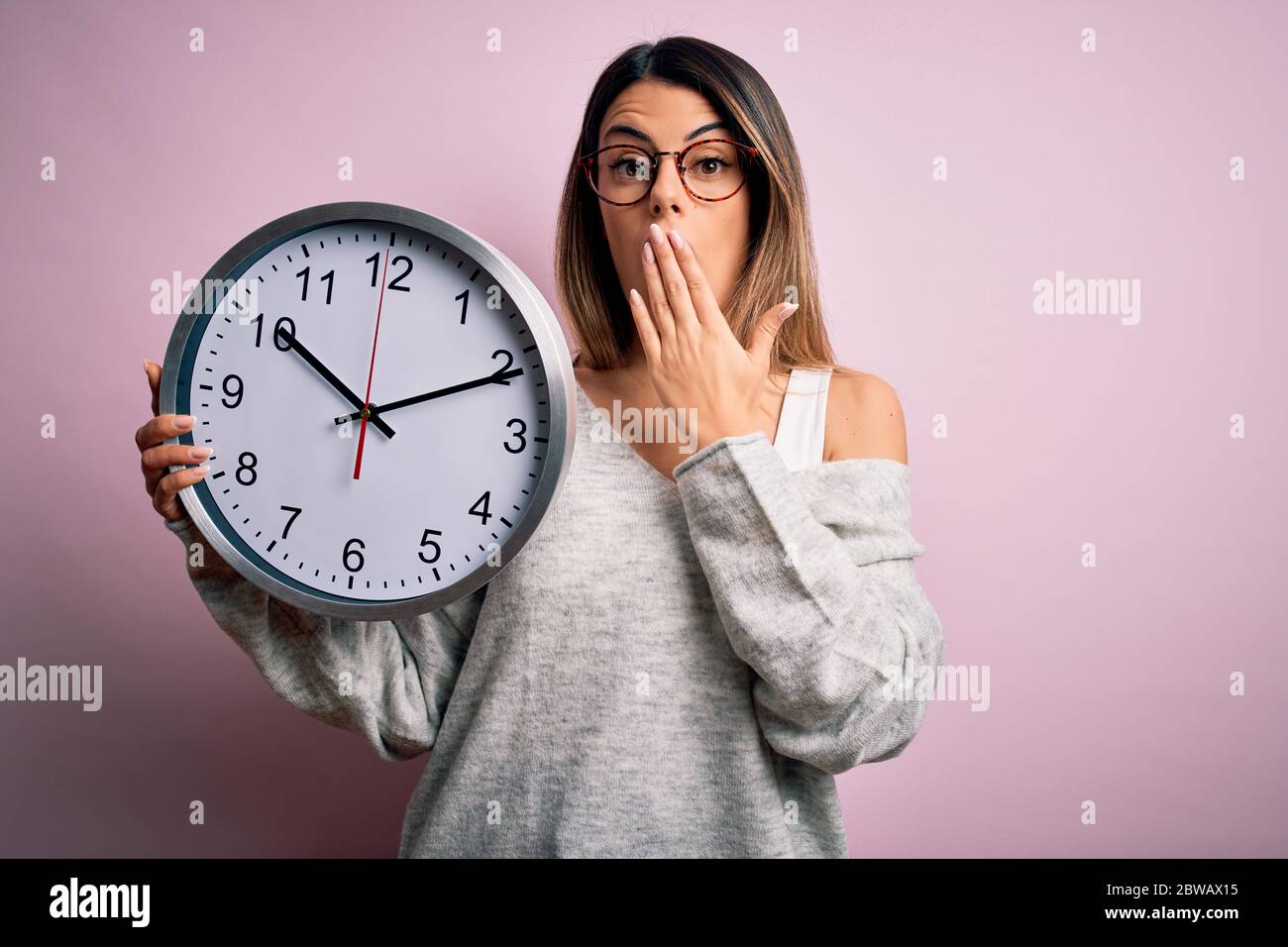Young beautiful brunette woman wearing glasses doing countdown using ...