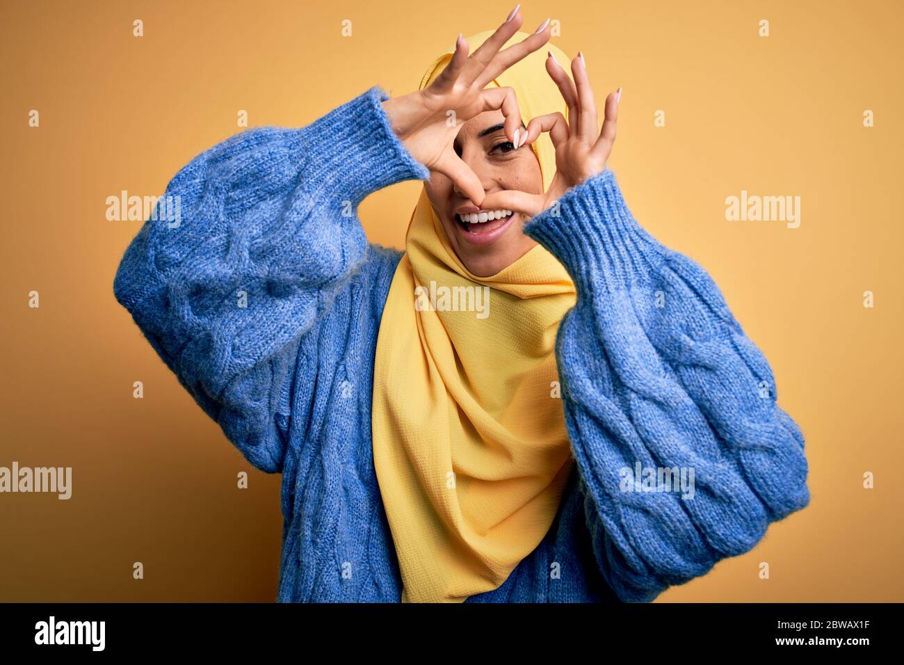Young beautiful brunette muslim woman wearing arab hijab over isolated ...