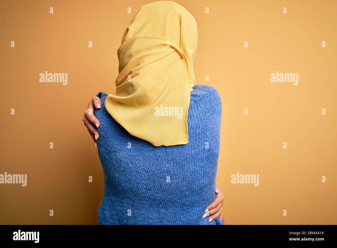 Young beautiful brunette muslim woman wearing arab hijab over isolated ...