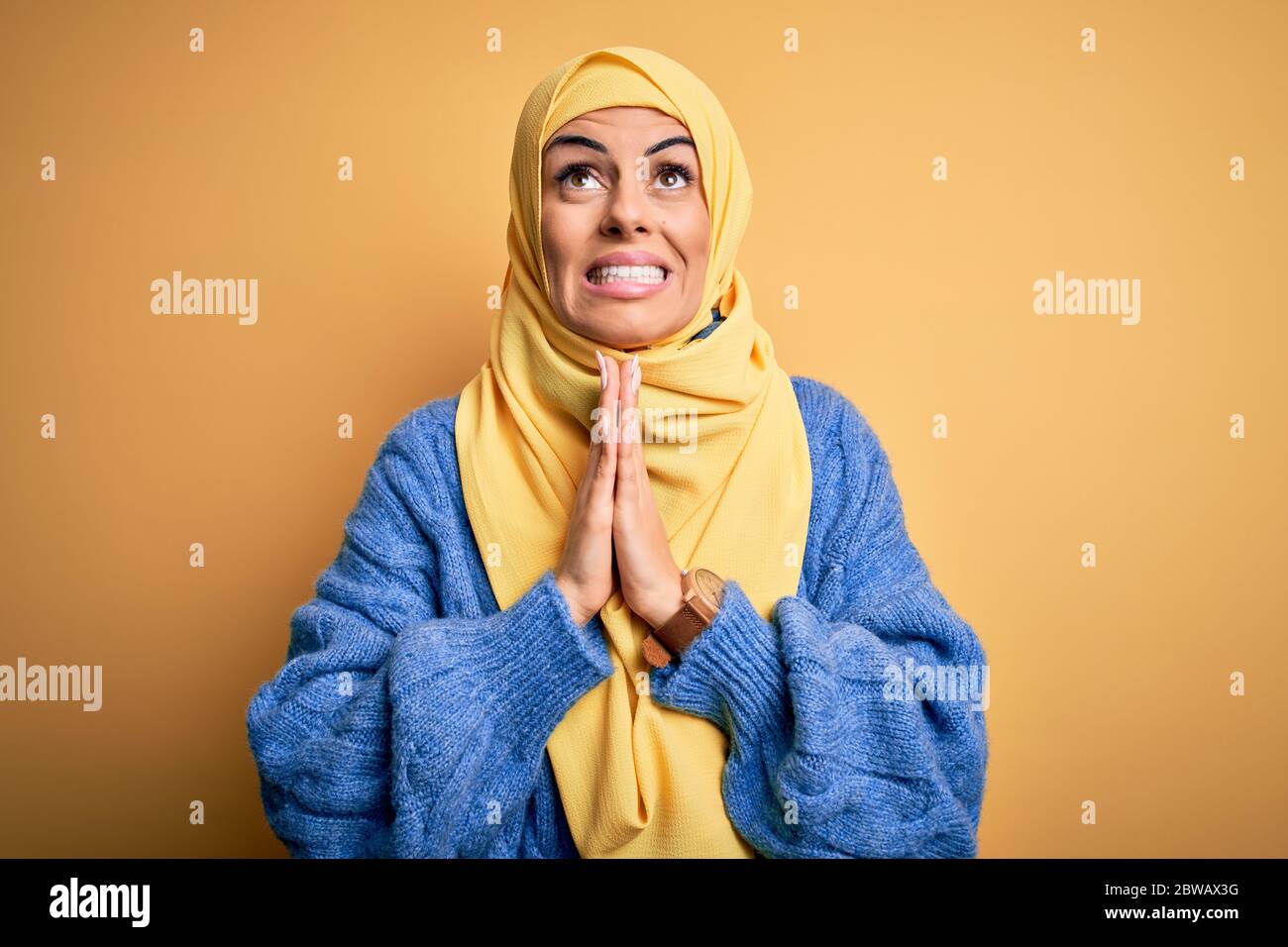 Young beautiful brunette muslim woman wearing arab hijab over isolated ...