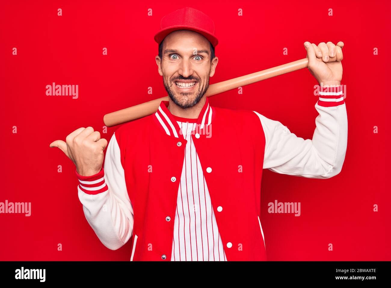 Young handsome player man wearing sportswear playing baseball using bat ...