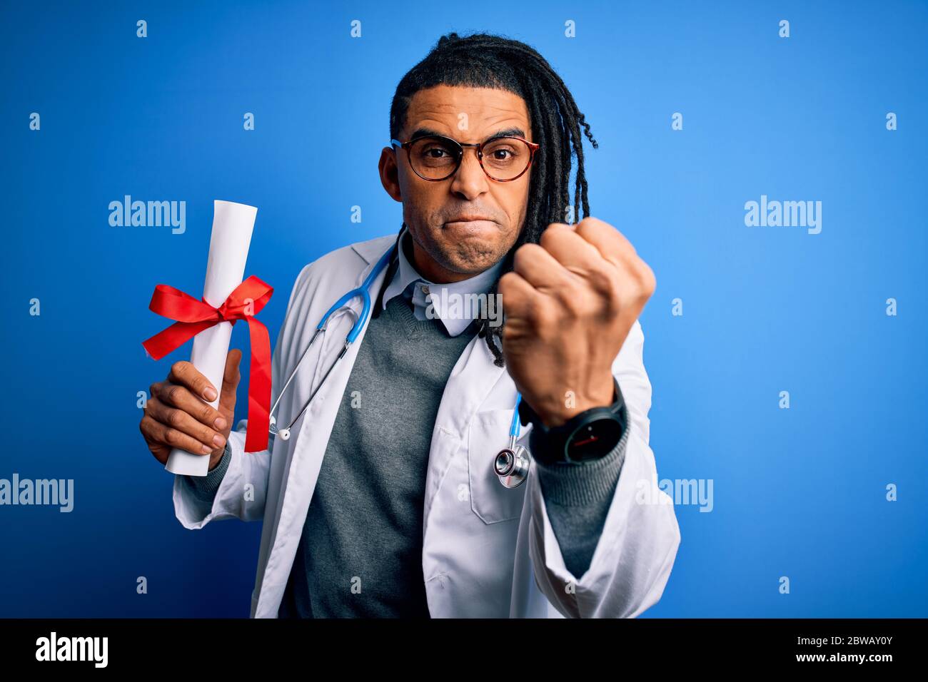 African american doctor man with dreadlocks wearing stethoscope holding ...