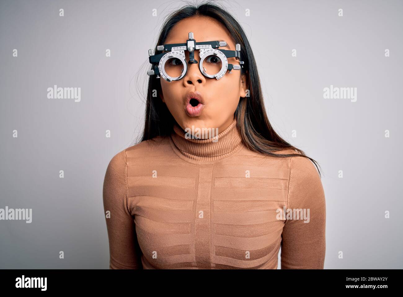 Young asian optical girl controlling eyesight using optometry glasses ...
