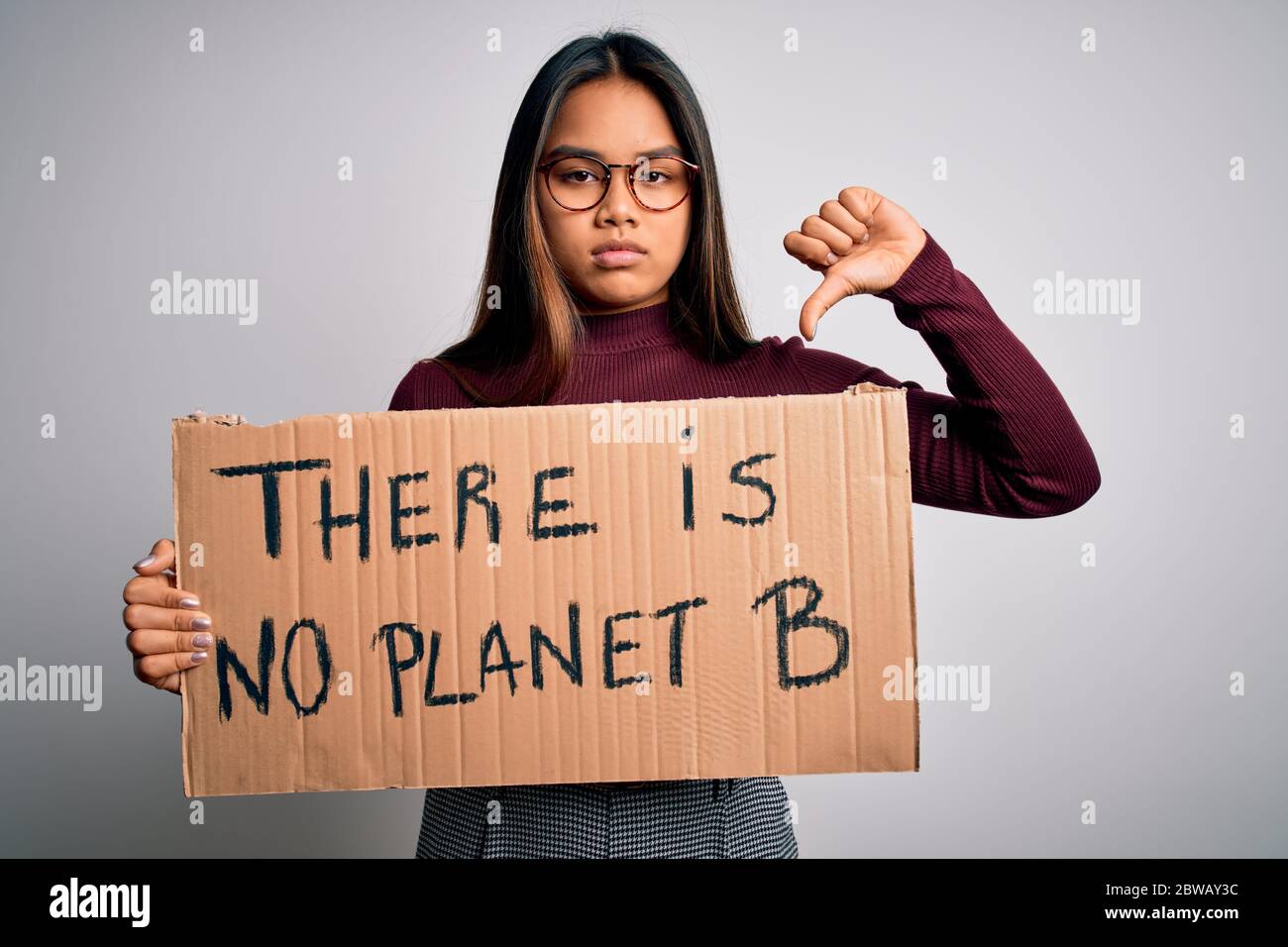 Young asian activist girl asking for environment holding banner with ...