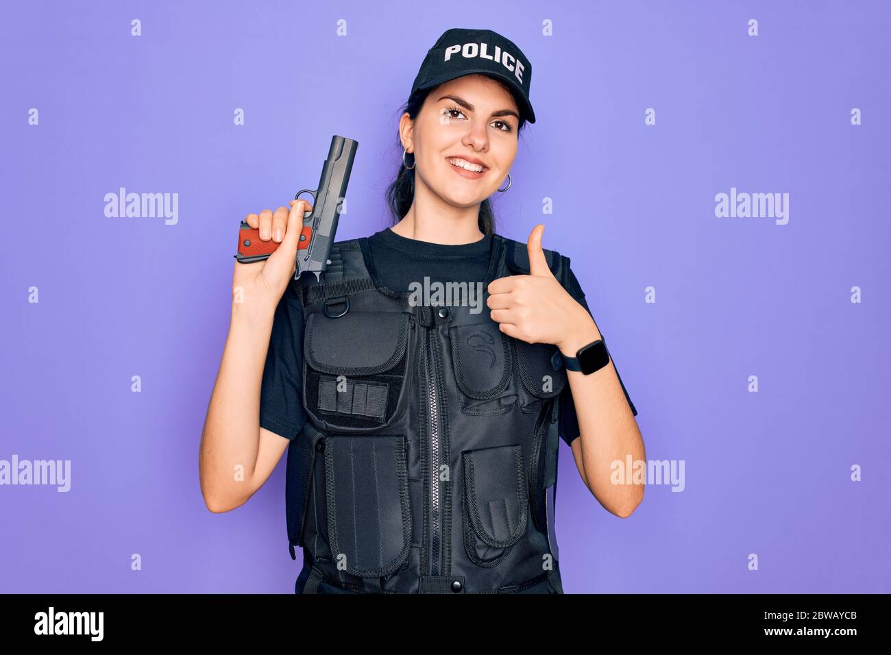 Young police woman wearing security bulletproof vest uniform and ...