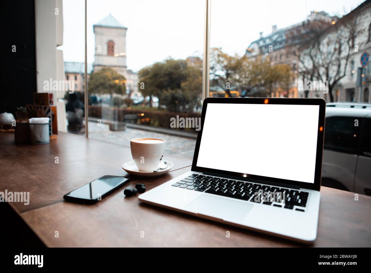 laptop with white screen in cafe table near window Stock Photo - Alamy