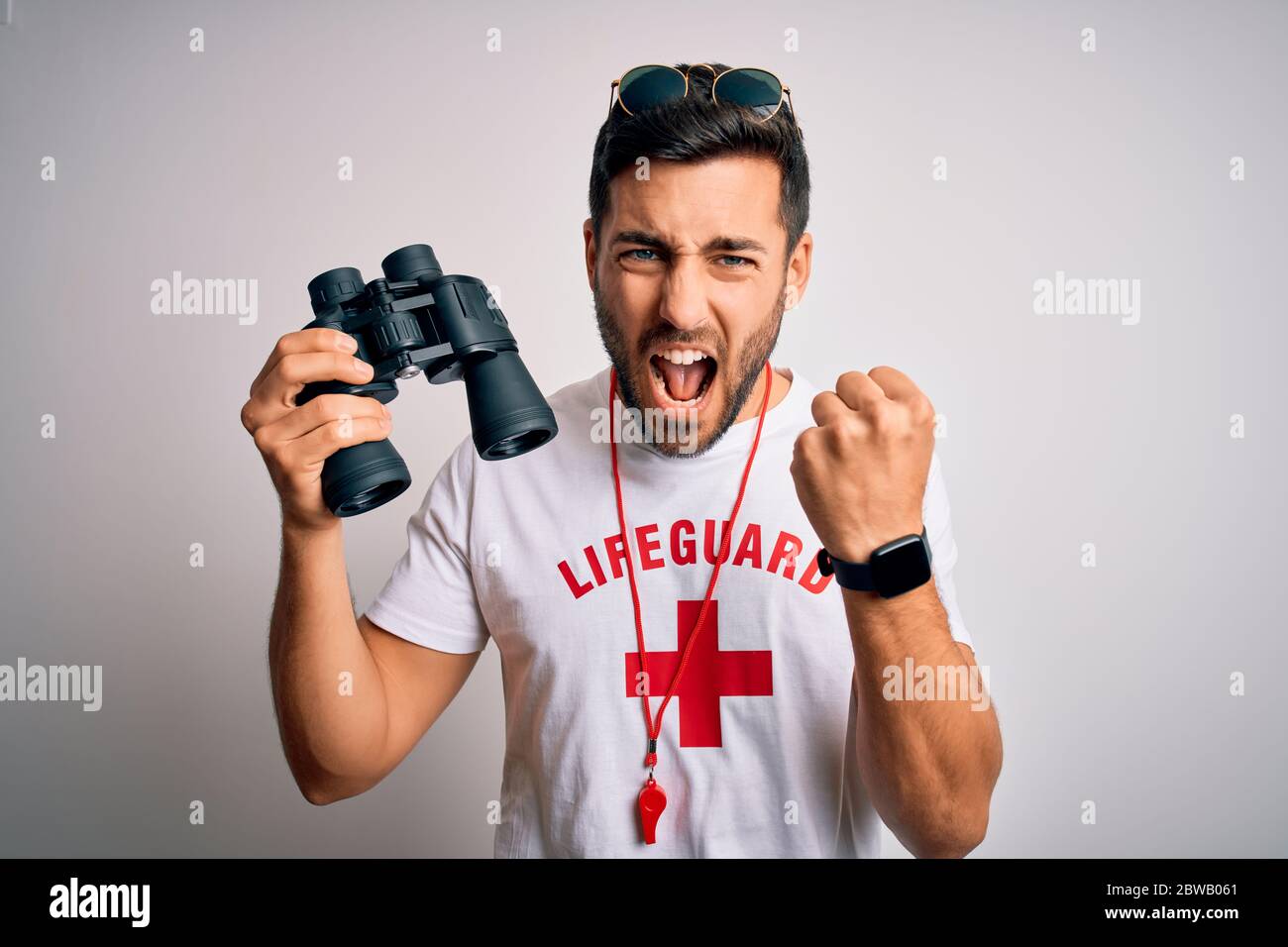 Young lifeguard man with beard wearing t-shirt with red cross and ...