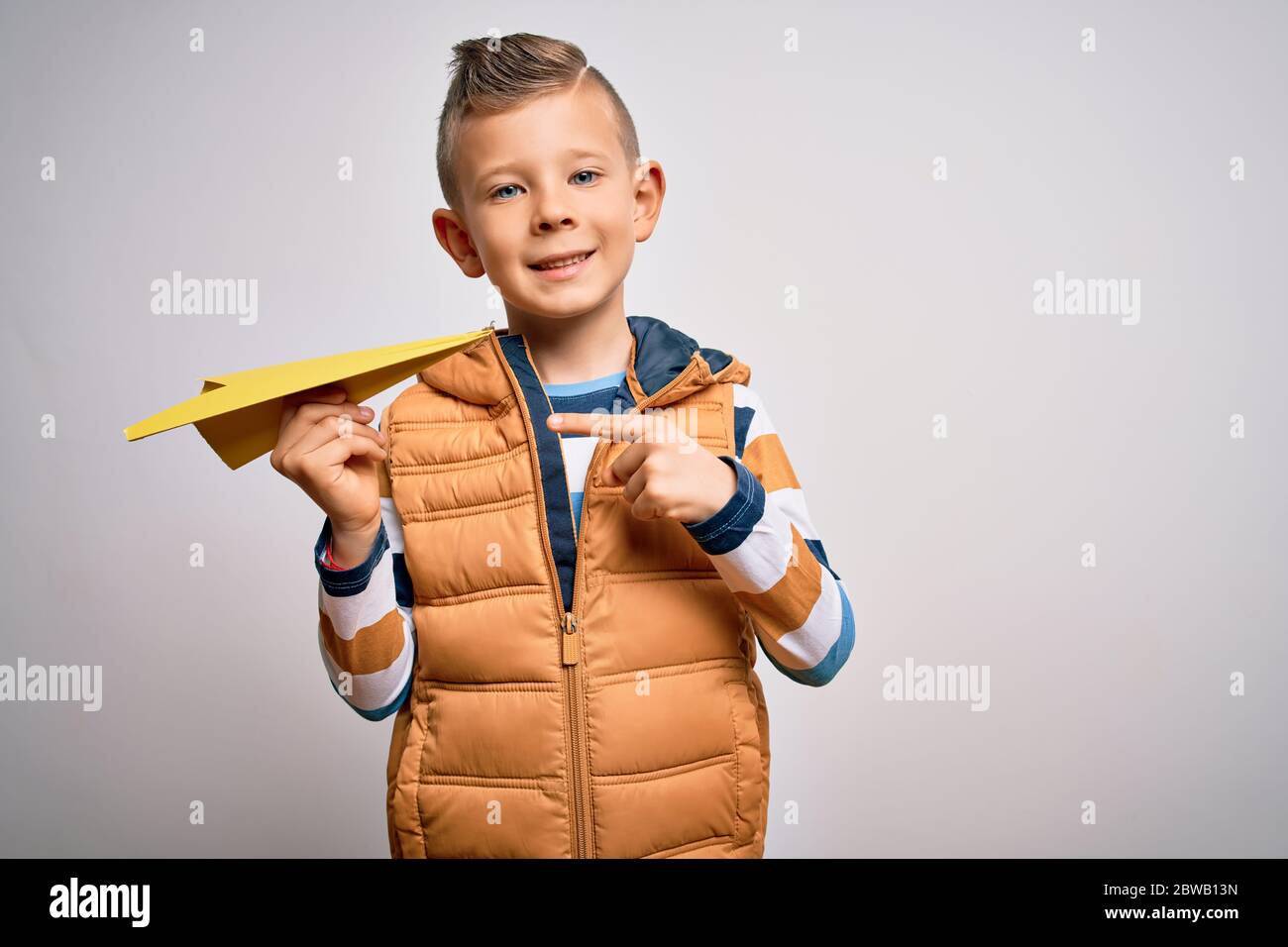 Young little caucasian kid having fun and playing imagination fly with ...