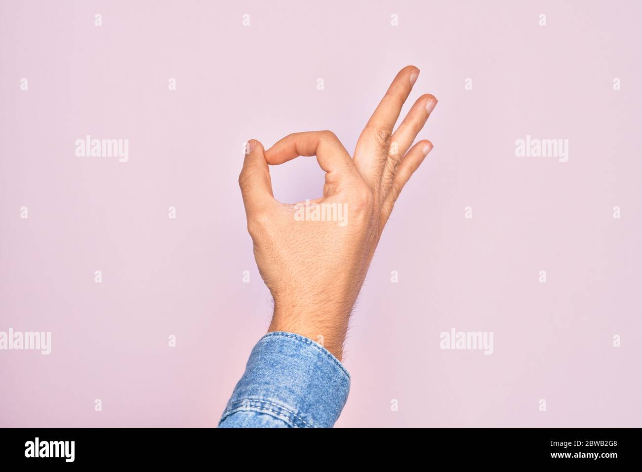 Hand of caucasian young man showing fingers over isolated pink ...