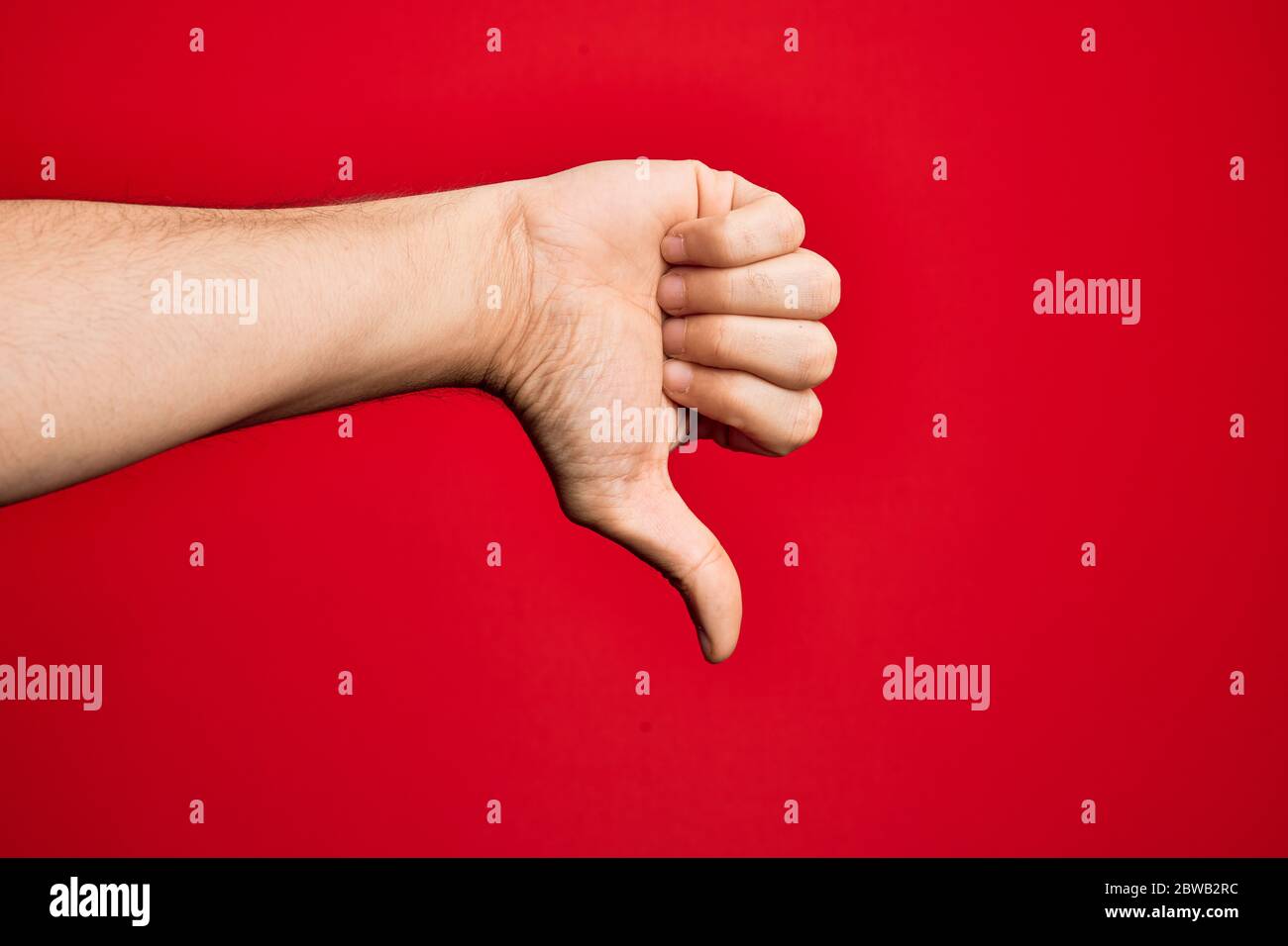 Hand of caucasian young man showing fingers over isolated red ...