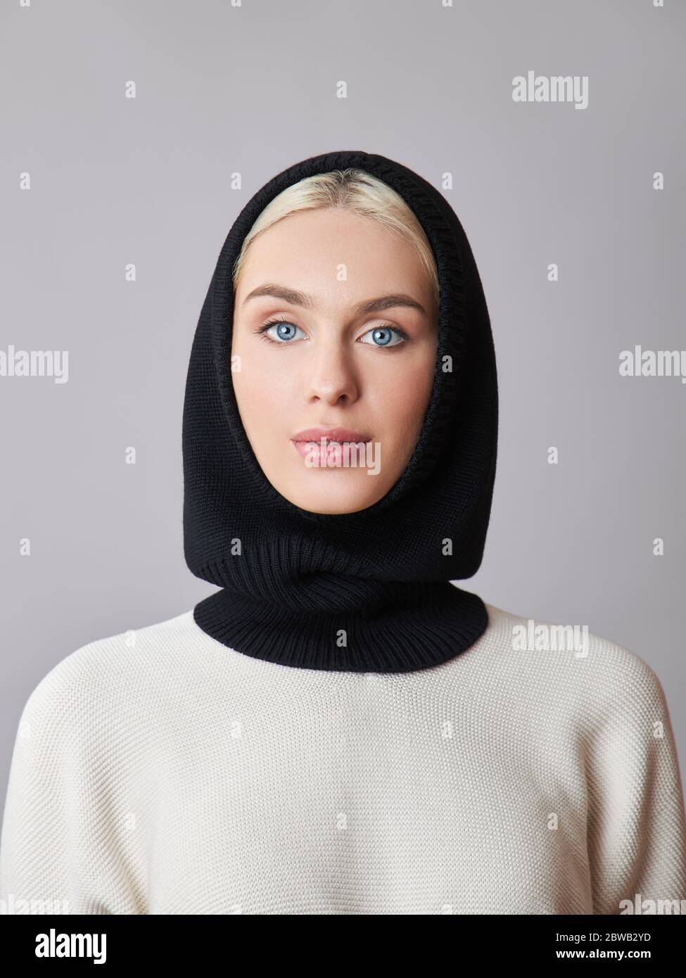 European Muslim woman with a blonde hair in a bonnet hood dressed on ...