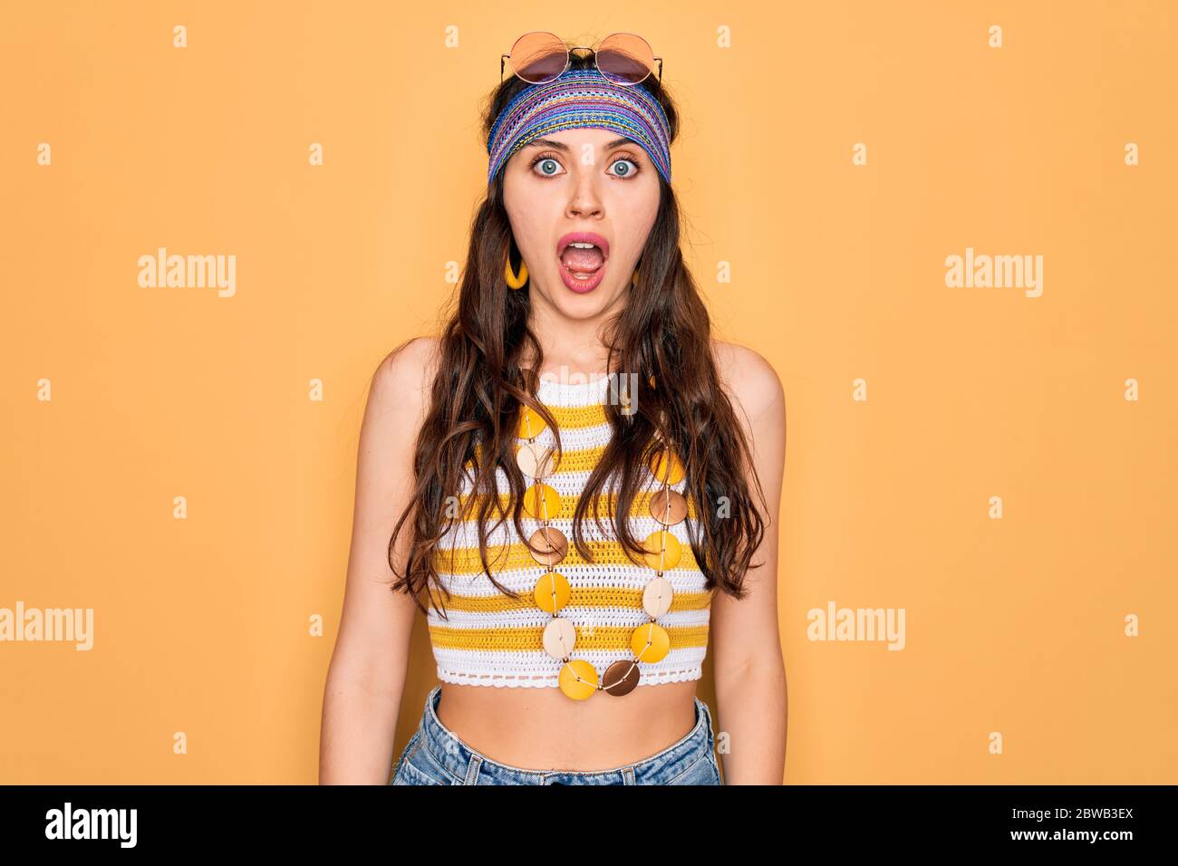 Young beautiful hippie woman with blue eyes wearing accesories and ...