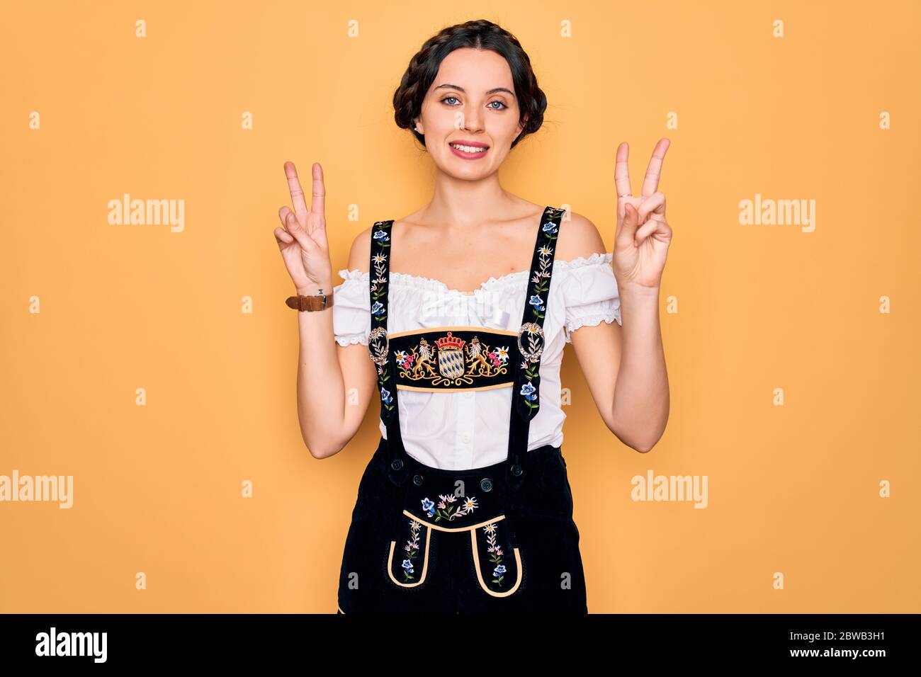 Young beautiful german woman with blue eyes wearing traditional ...