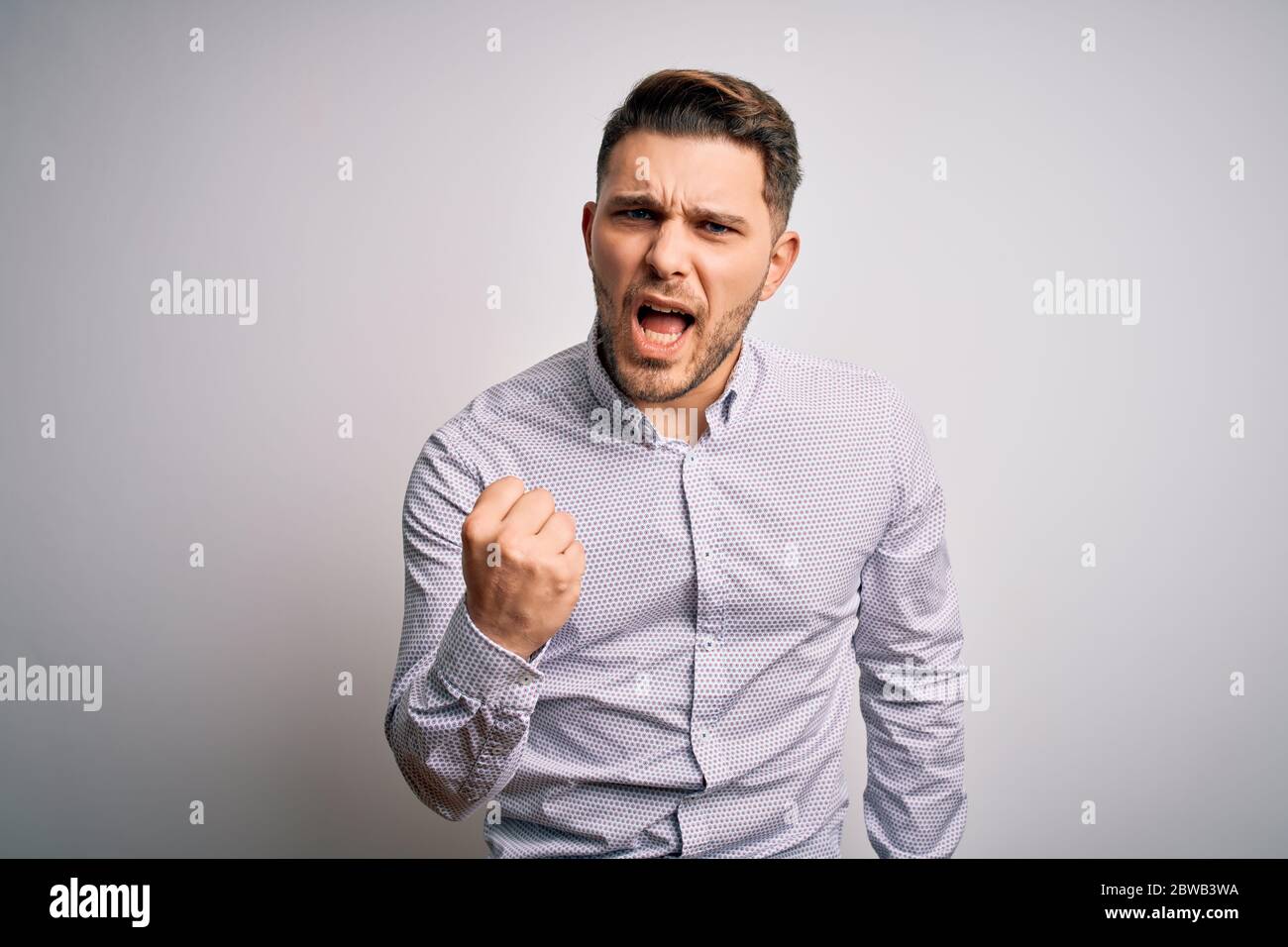 Young business man with blue eyes standing over isolated background ...