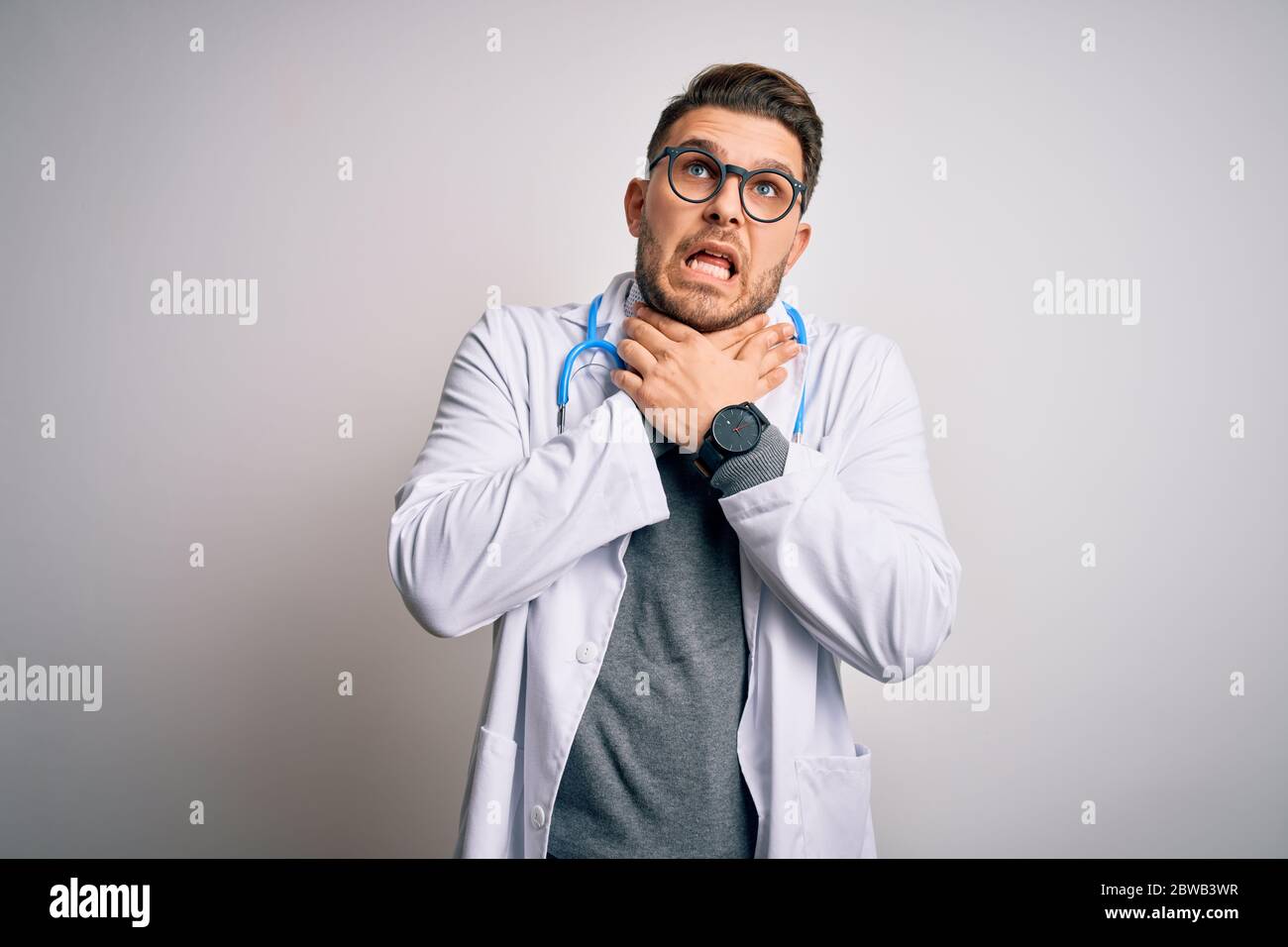 Young doctor man with blue eyes wearing medical coat and stethoscope ...