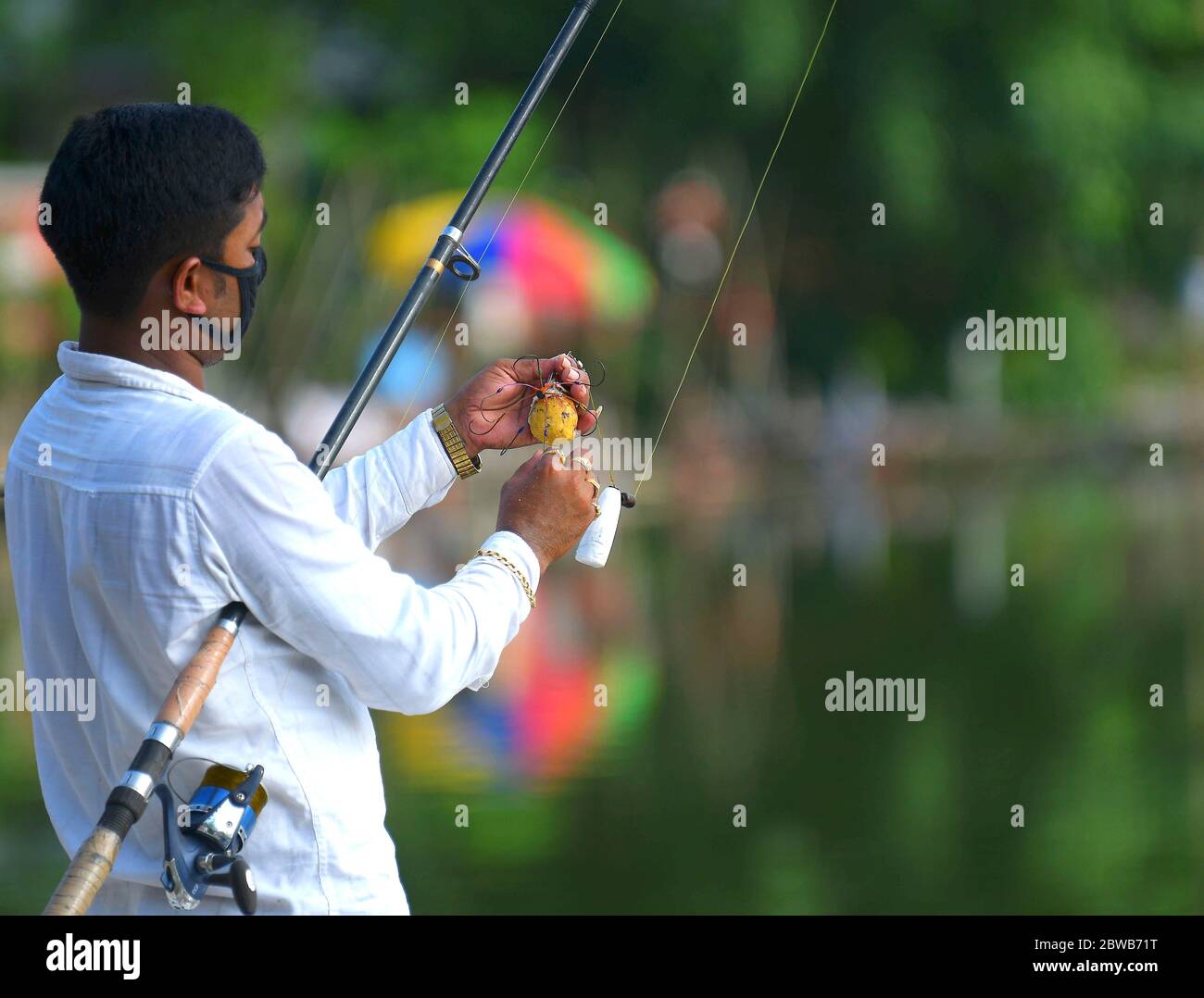Tripura, India. 31st May, 2020. An angler arranges his fishing gear on ...