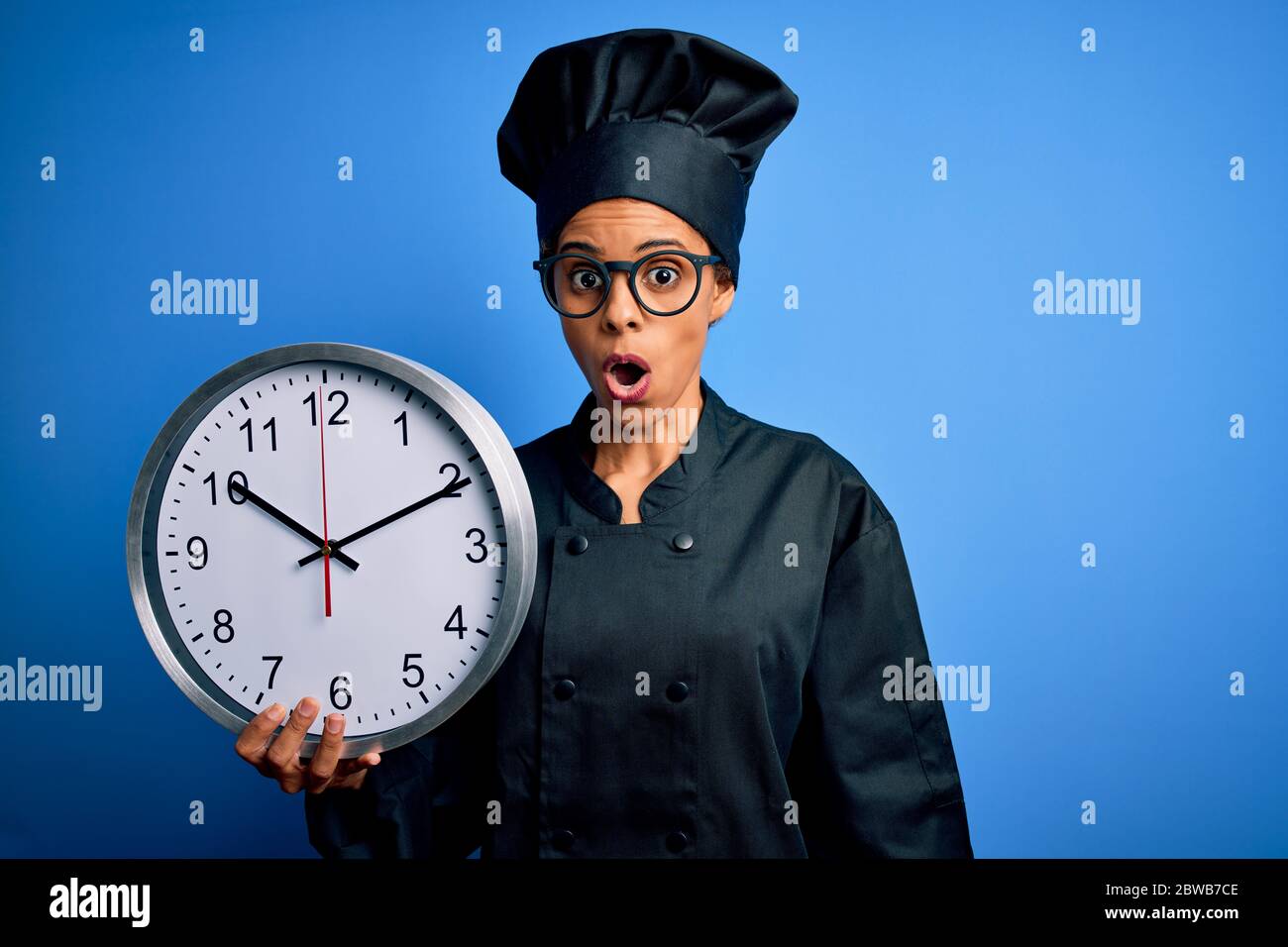 African american baker woman wearing cooker uniform and hat doing ...