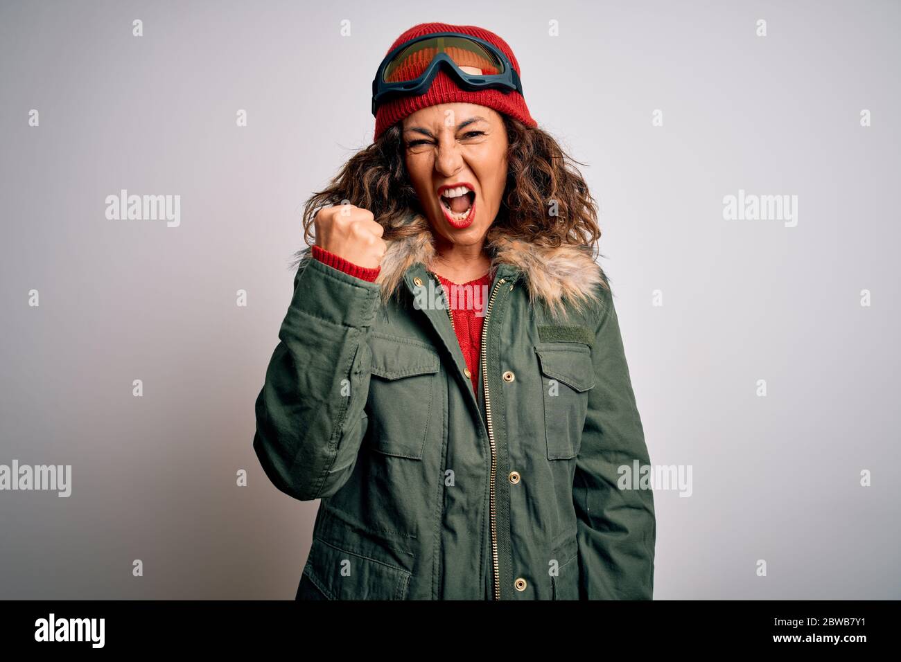 Middle age skier woman wearing snow sportswear and ski goggles over ...
