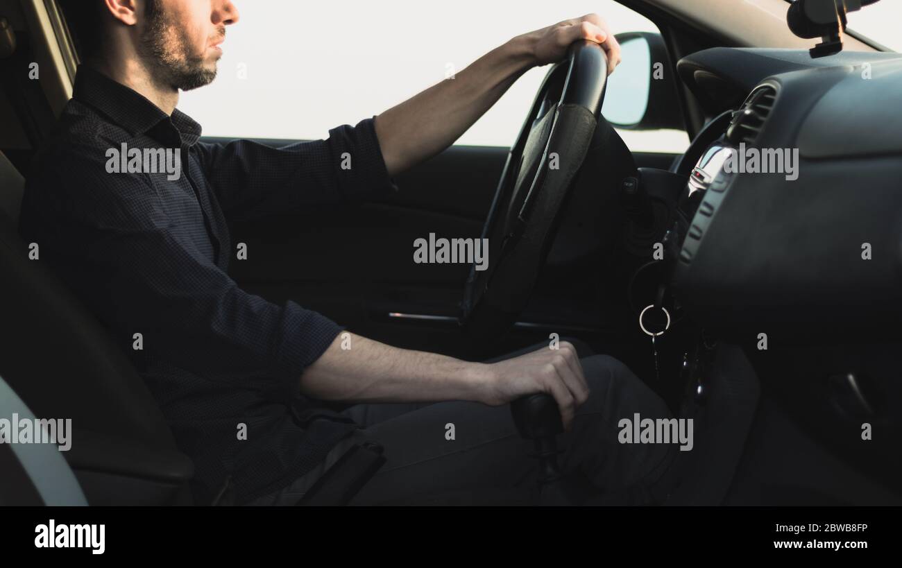 man inside a car at sunset Stock Photo - Alamy
