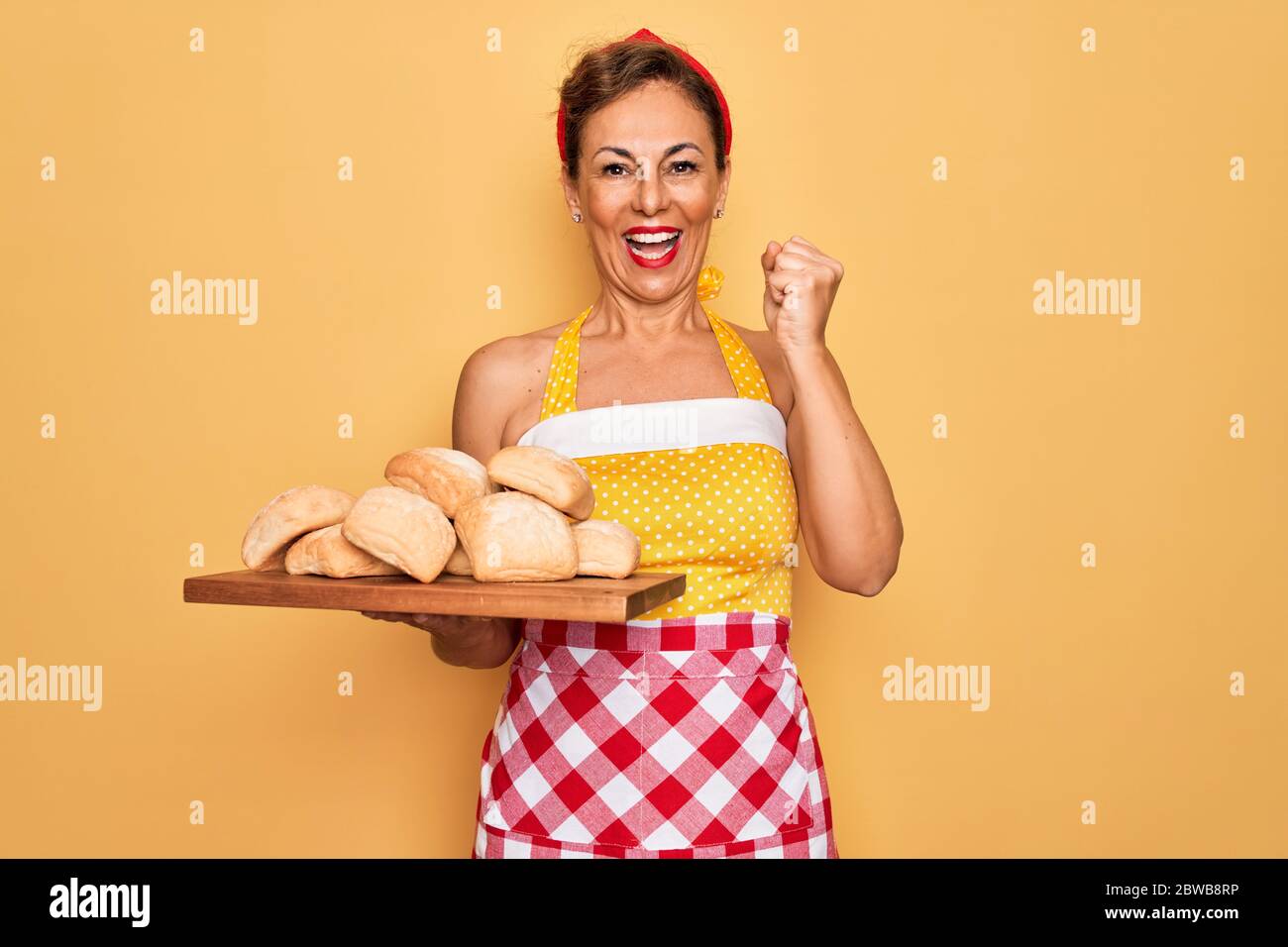 Middle age senior pin up housewife woman wearing 50s style retro dress ...