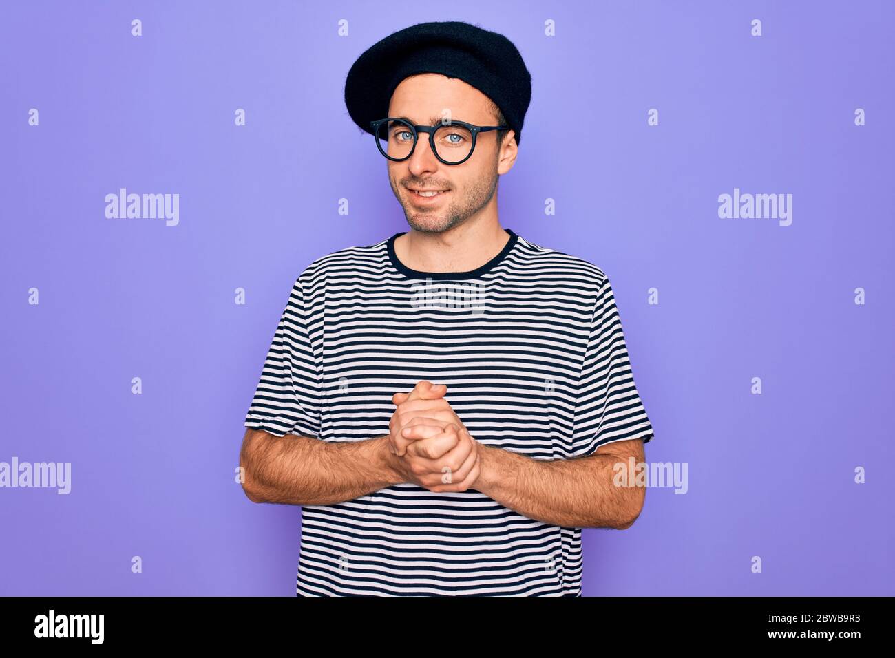 Handsome man with blue eyes wearing striped t-shirt and french beret ...