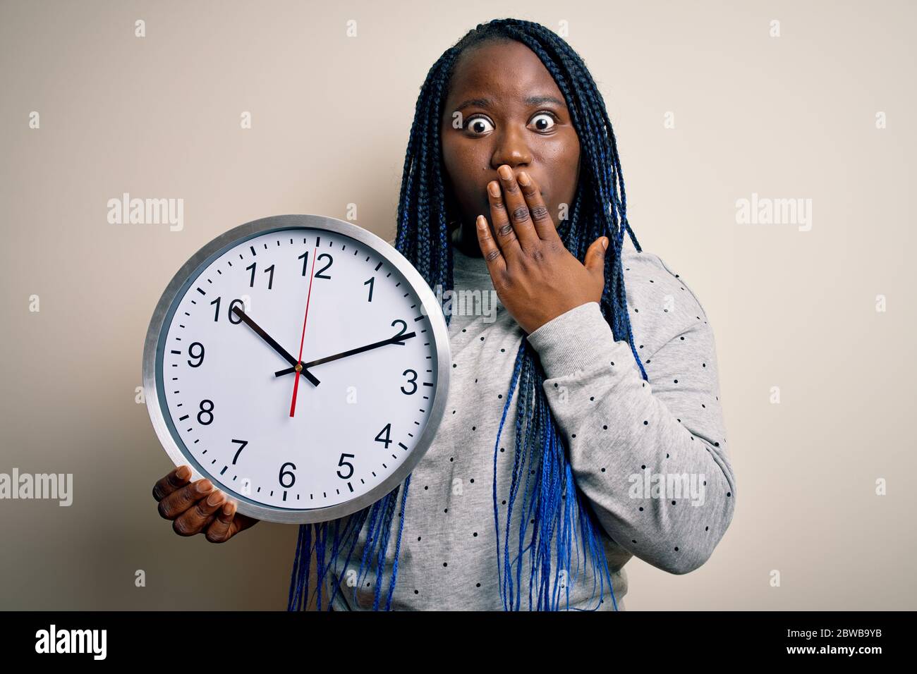 Young african american plus size woman with braids doing countdown ...