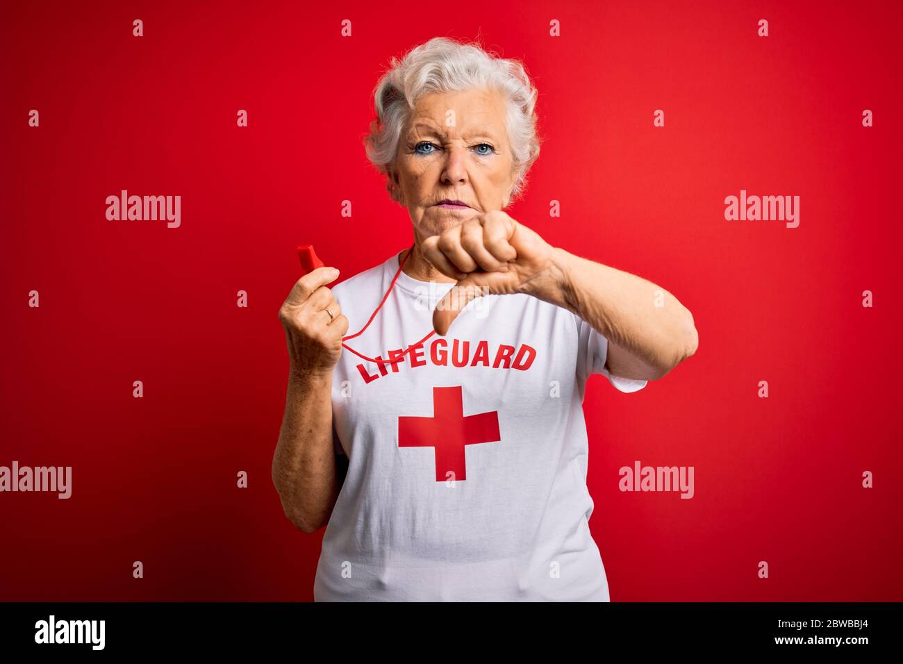 Senior beautiful grey-haired lifeguard woman wearing t-shirt with red ...
