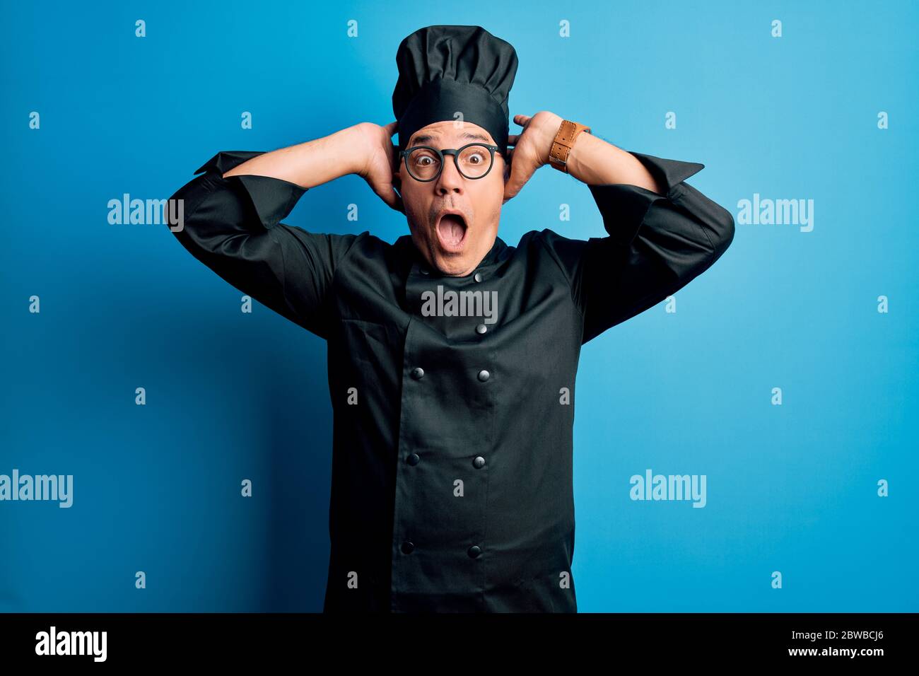 Middle age handsome grey-haired chef man wearing cooker uniform and hat ...