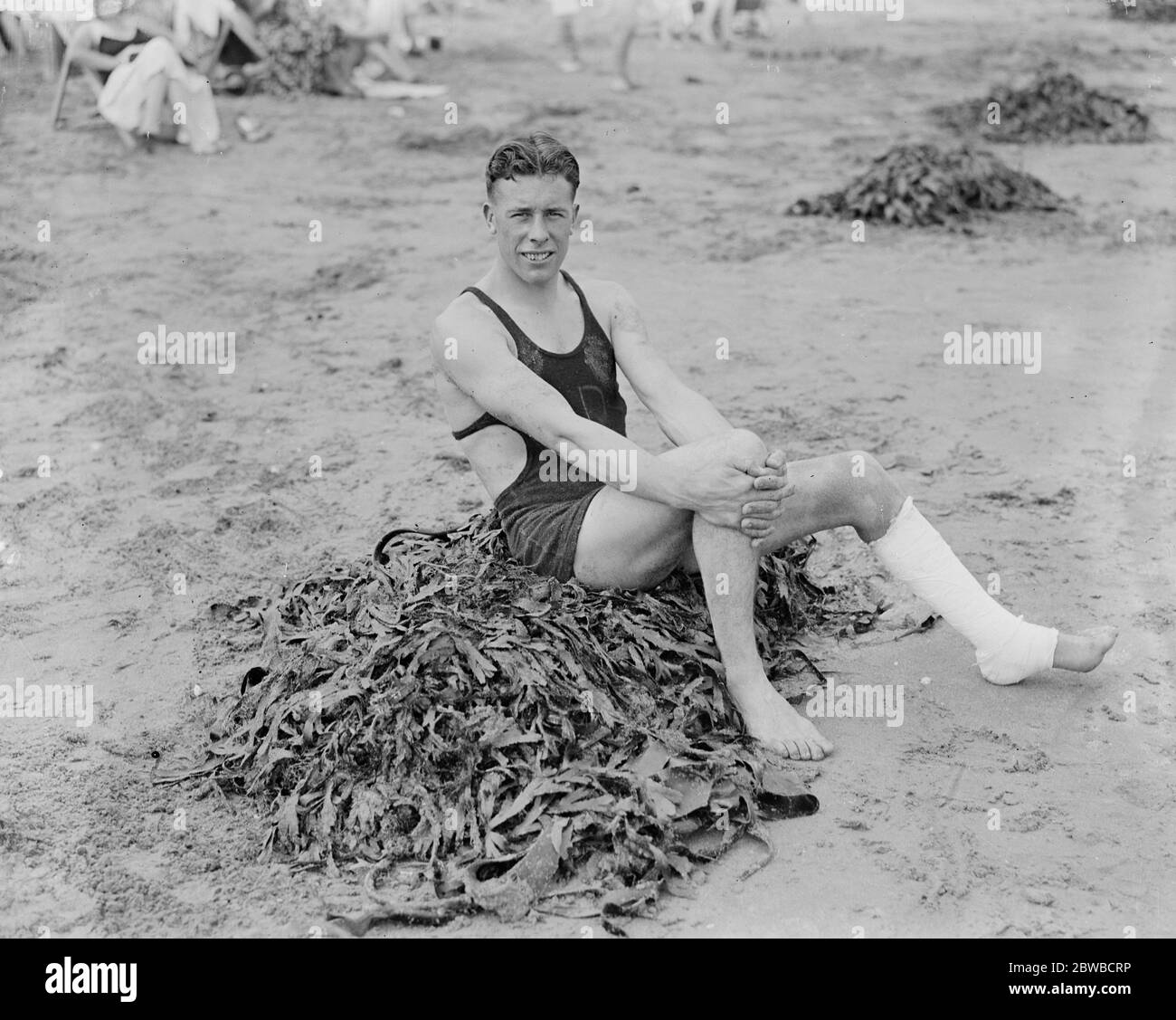 Claude Rye , Wimbledon speedway rider , relaxing on the beach at ...