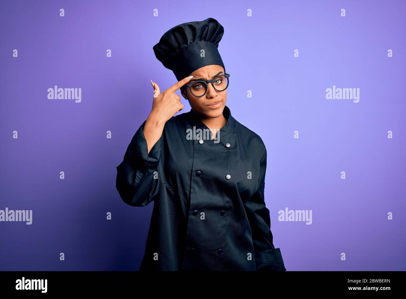 Young african american chef girl wearing cooker uniform and hat over ...