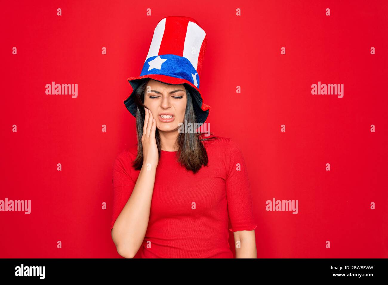 Young beautiful brunette woman wearing united states hat celebrating ...