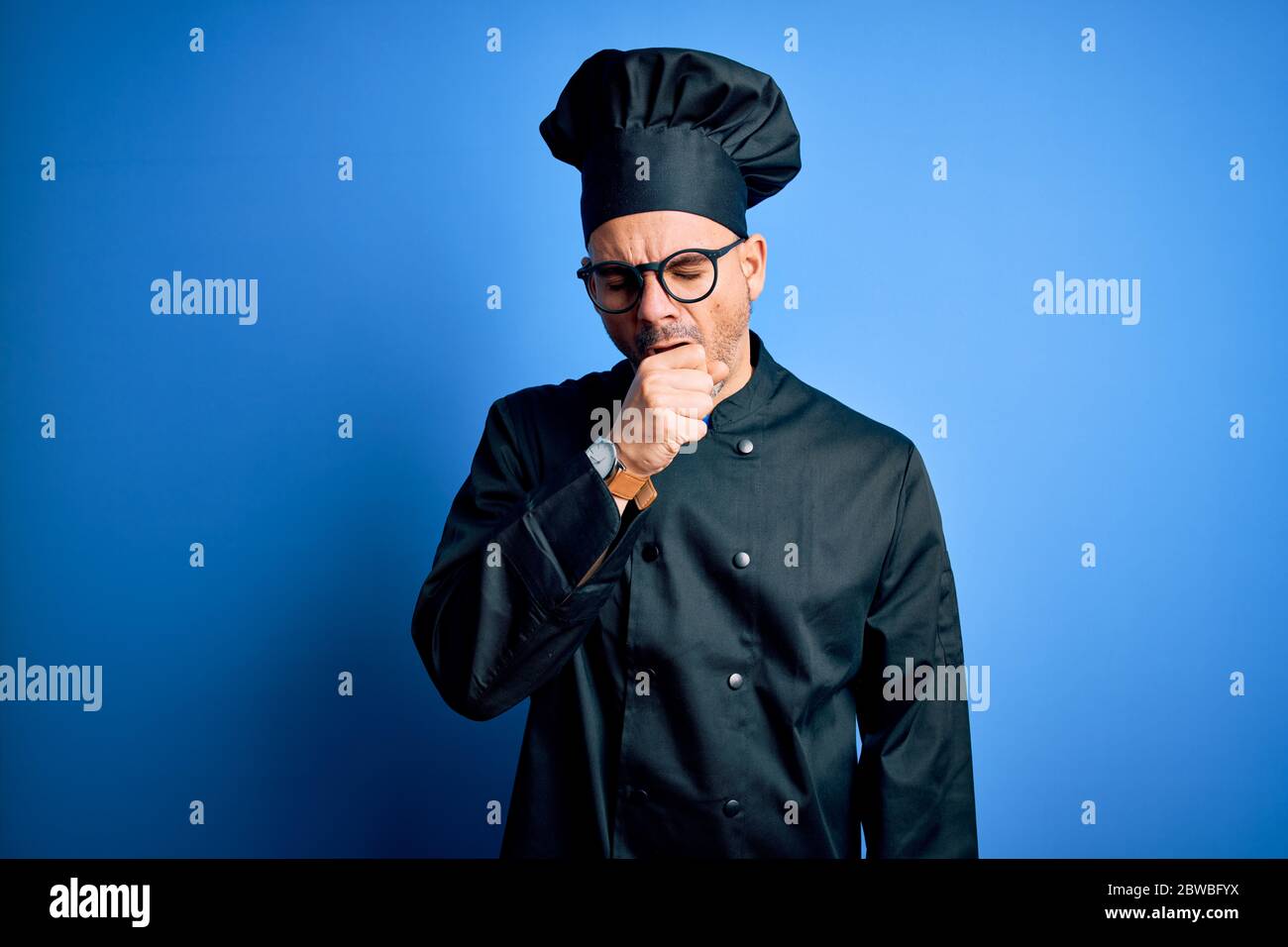 Young handsome chef man wearing cooker uniform and hat over isolated ...