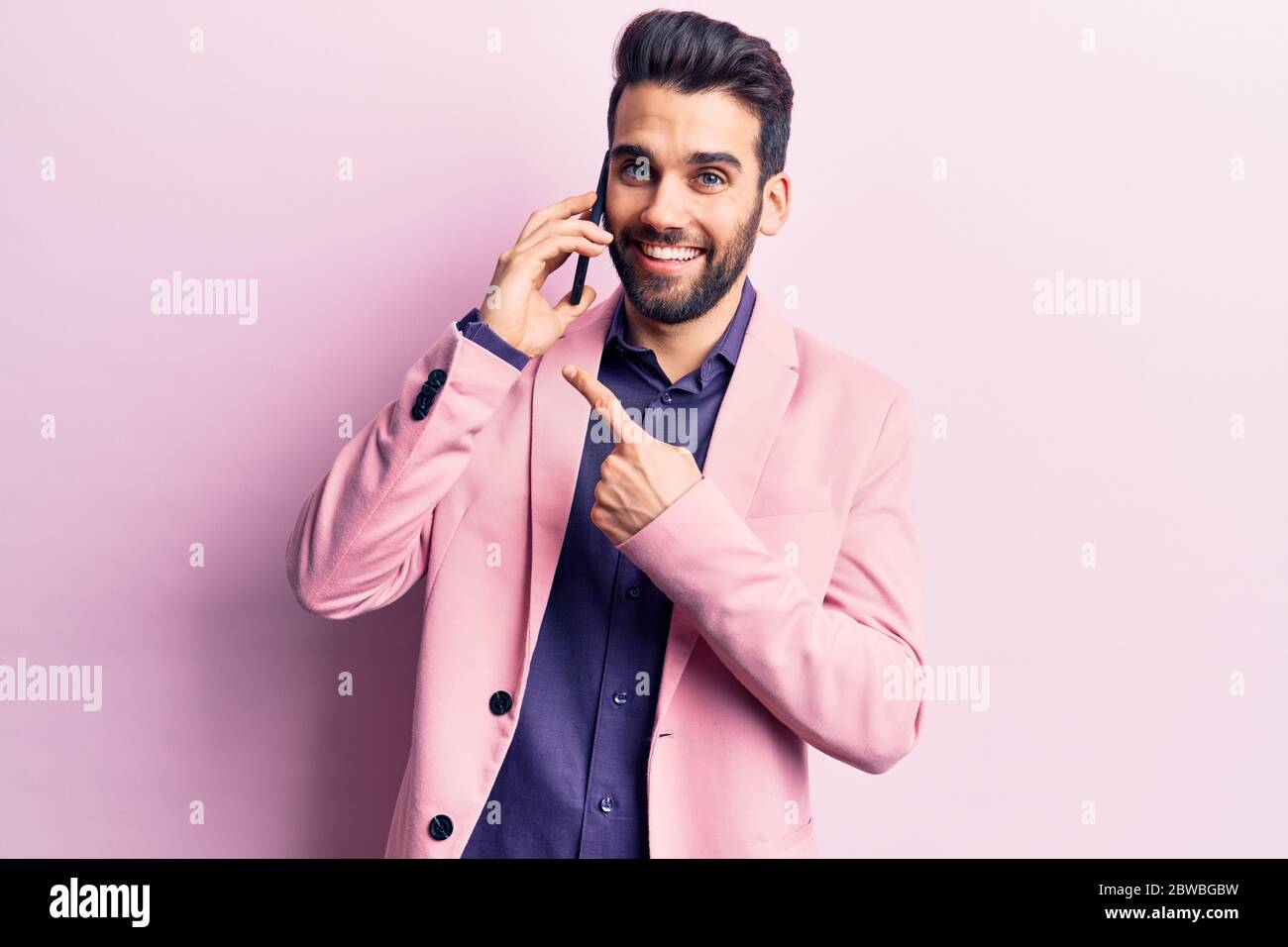 Young handsome man with beard having conversation talking on the ...