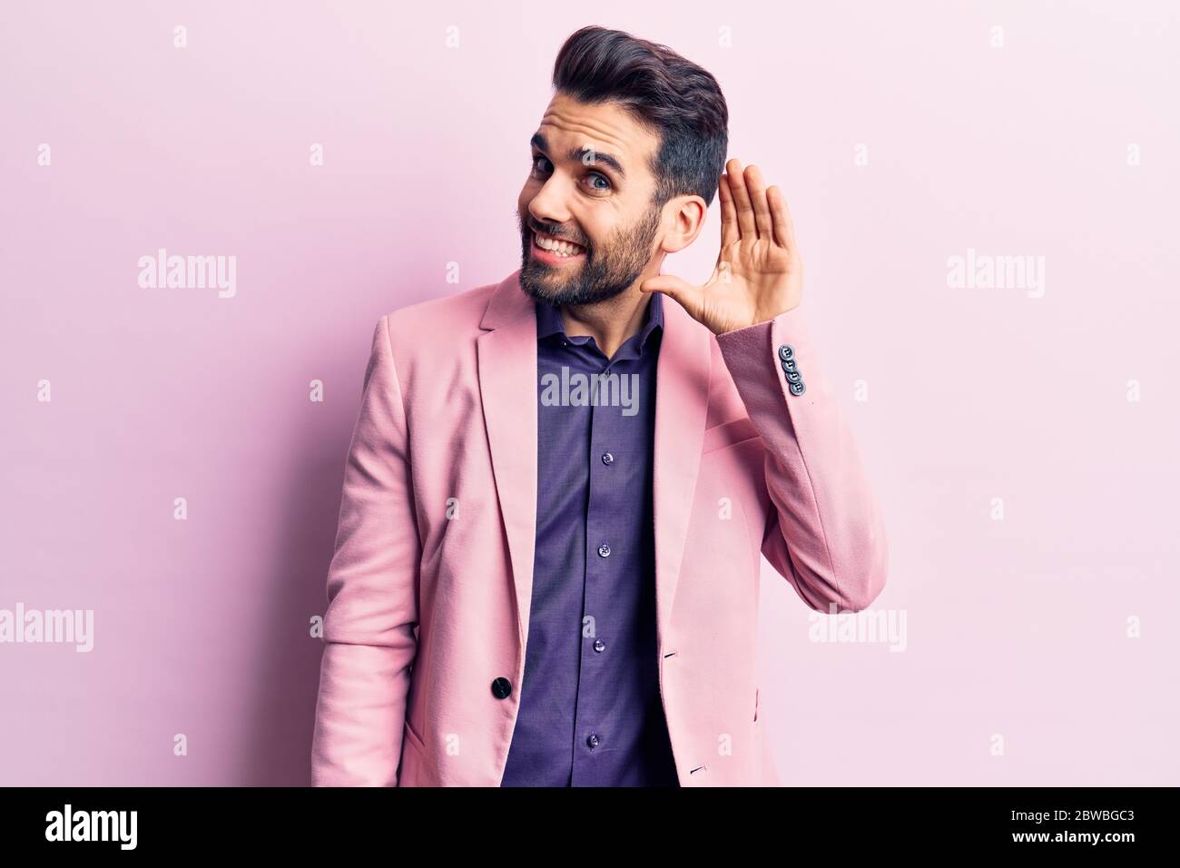 Young handsome man with beard wearing elegant jacket smiling with hand ...