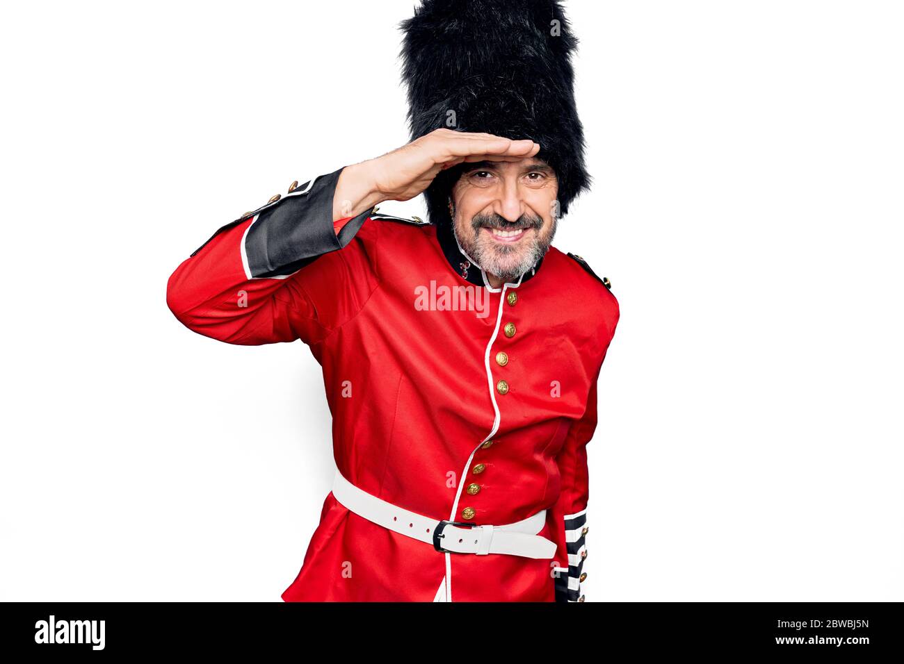 Middle age handsome wales guard man wearing traditional uniform over ...