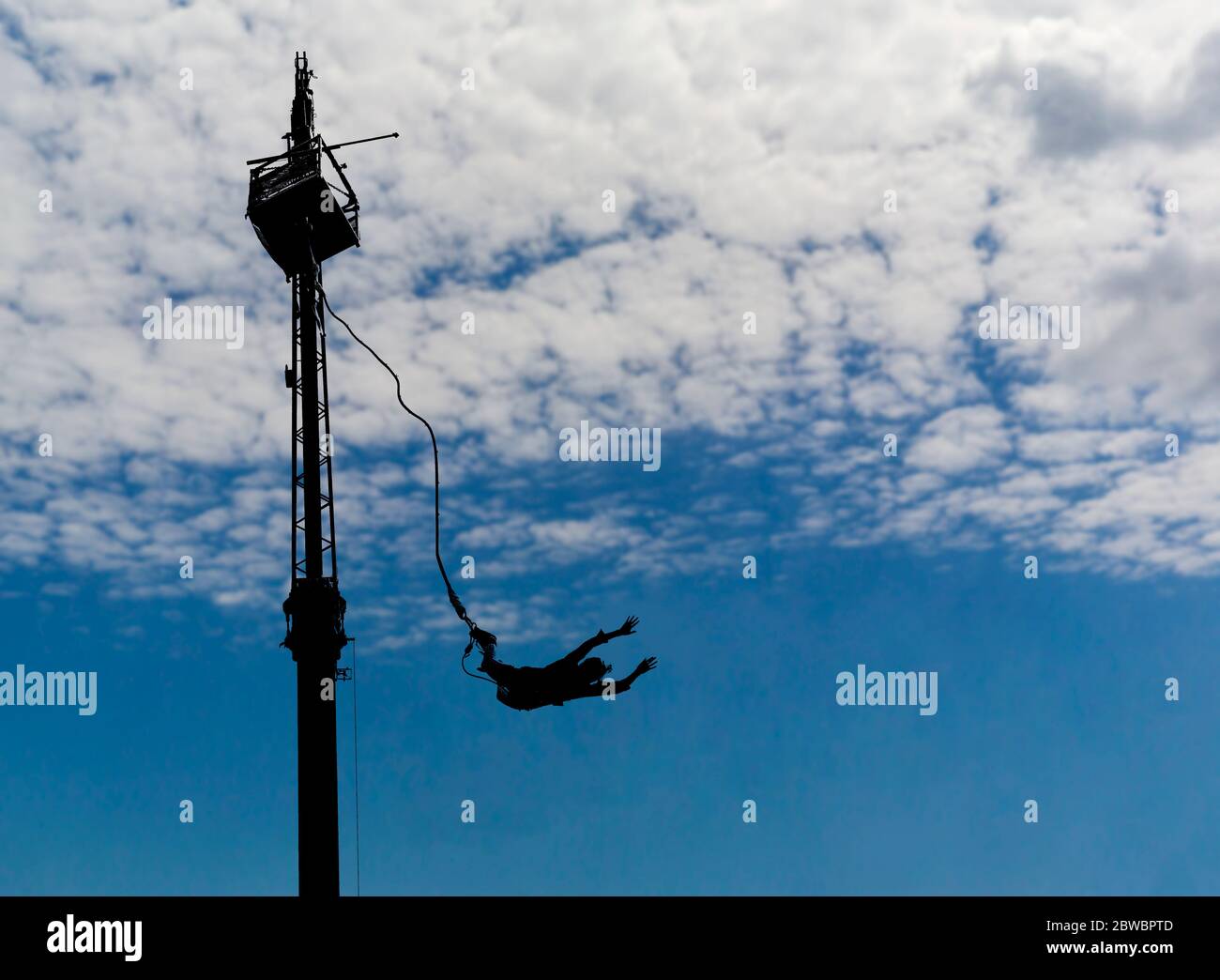 bungee jumping on fluffy clouds in the blue sky Stock Photo - Alamy