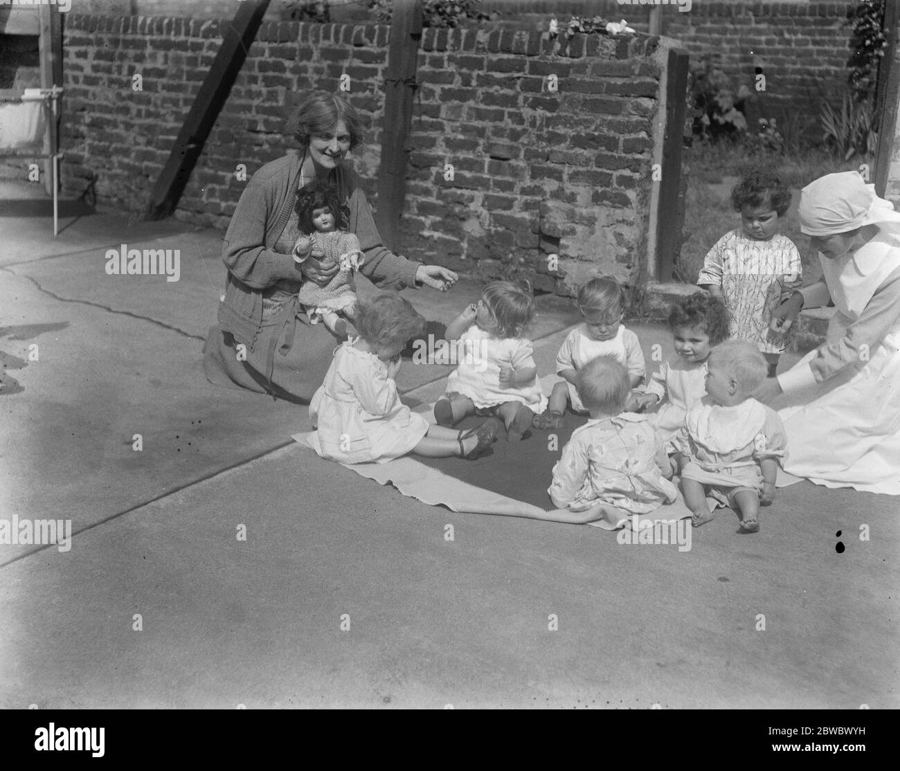 Joan of Arc among the babies . Miss Sybil Thorndike , who so ...