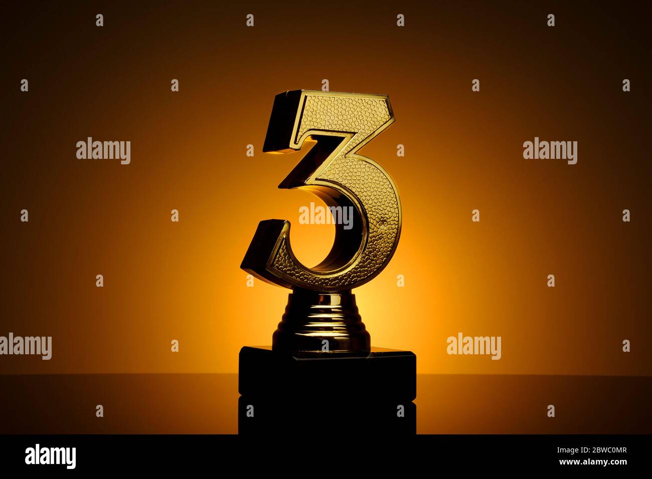Gold number three trophy for the third placed runner up in a ...
