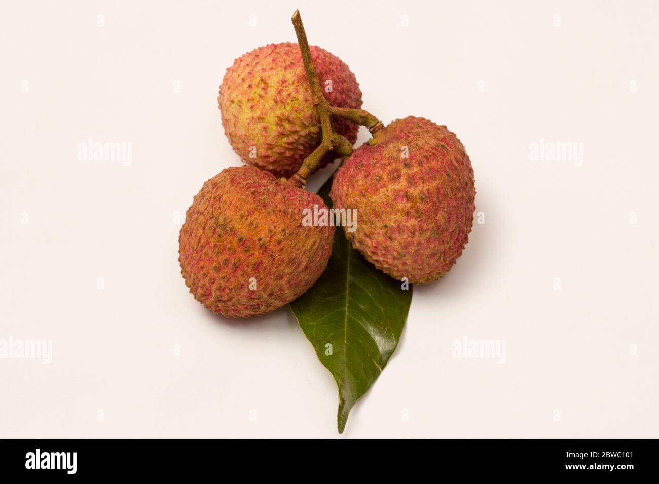 Close-up view of ripe lychee on white background Stock Photo - Alamy