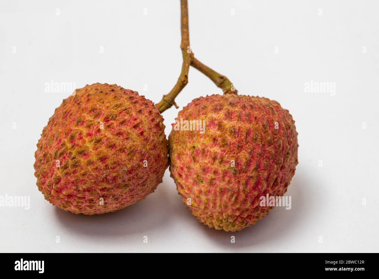 Close-up view of ripe lychee on white background Stock Photo - Alamy